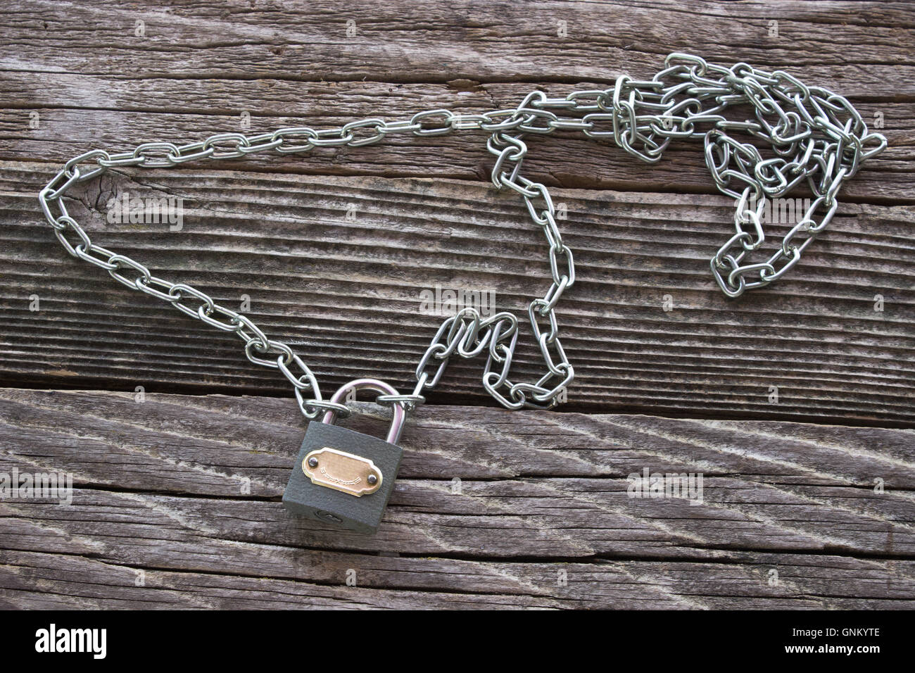 Padlock and chain on wooden background Stock Photo - Alamy