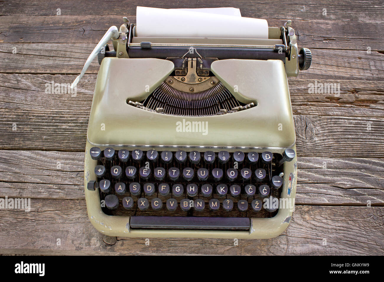 Old typewriter with blank paper on wooden background Stock Photo - Alamy