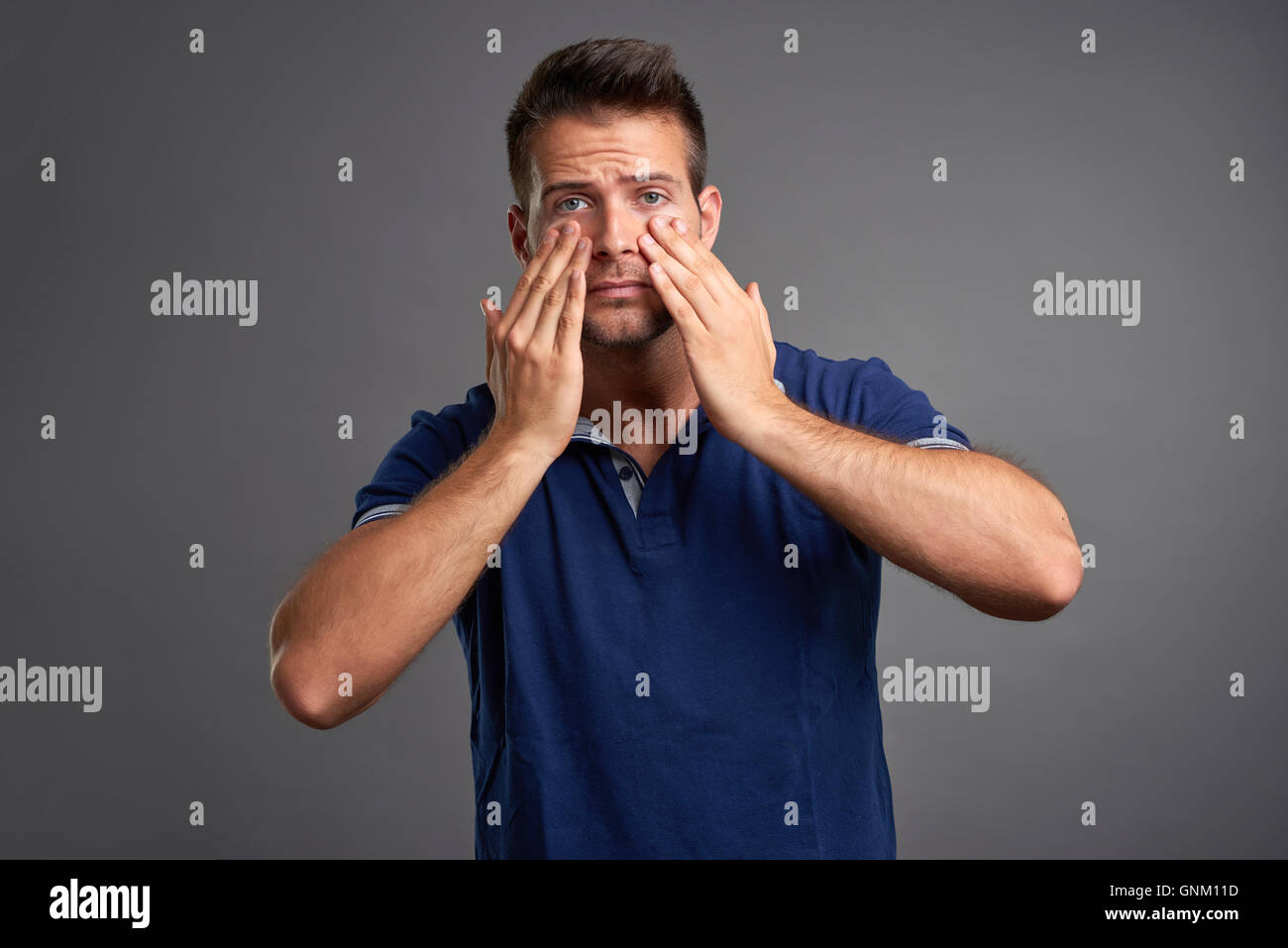 A handsome young man checking the skin on his face Stock Photo - Alamy