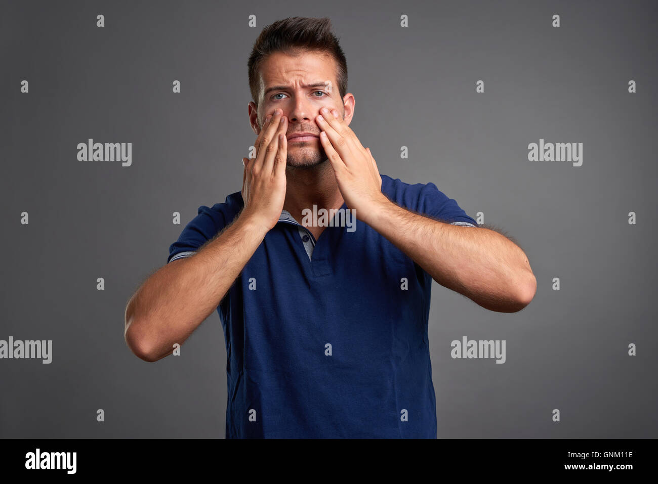 A handsome young man checking the skin on his face Stock Photo - Alamy