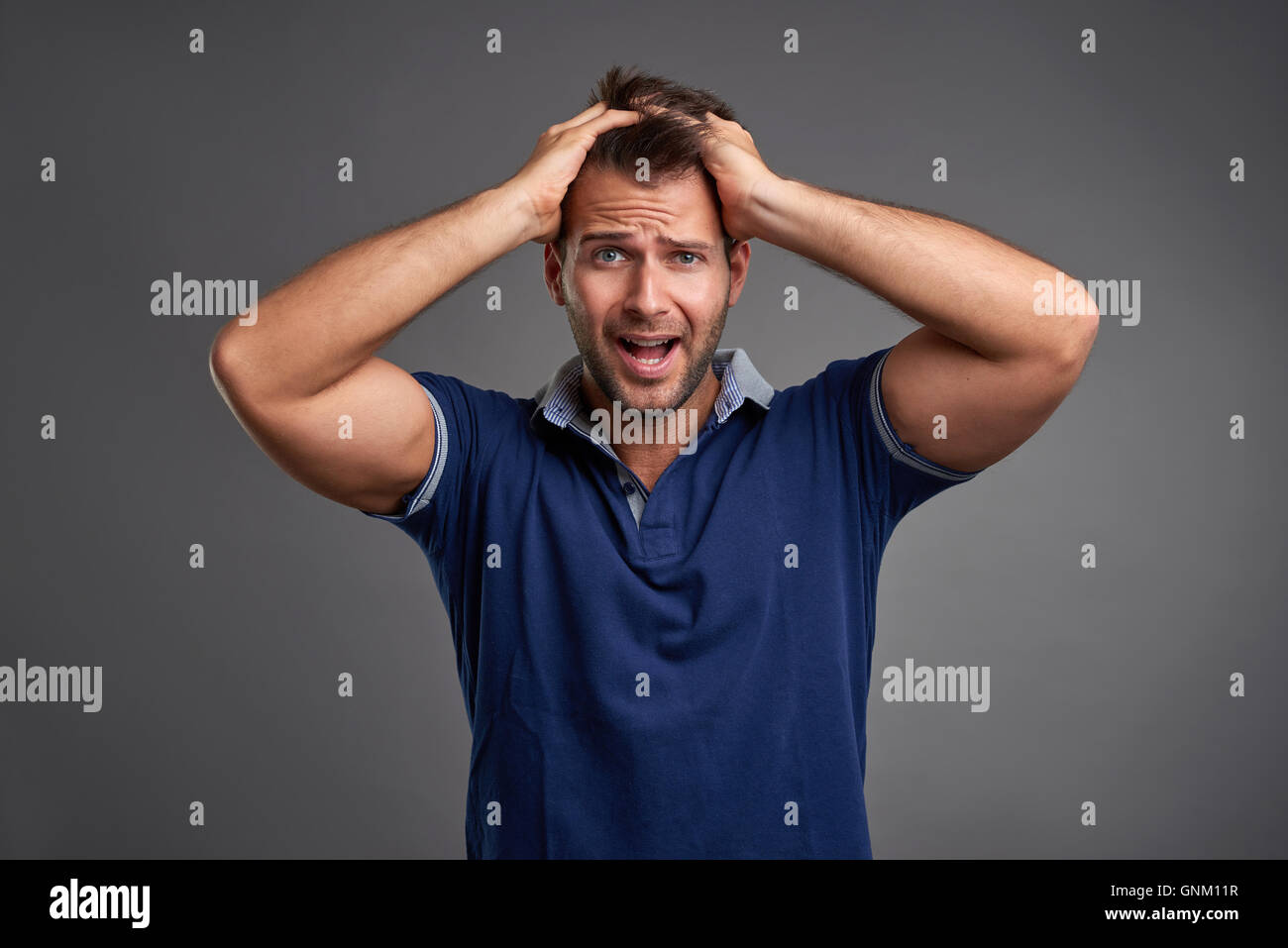 A handsome young man feeling shocked and screaming Stock Photo - Alamy