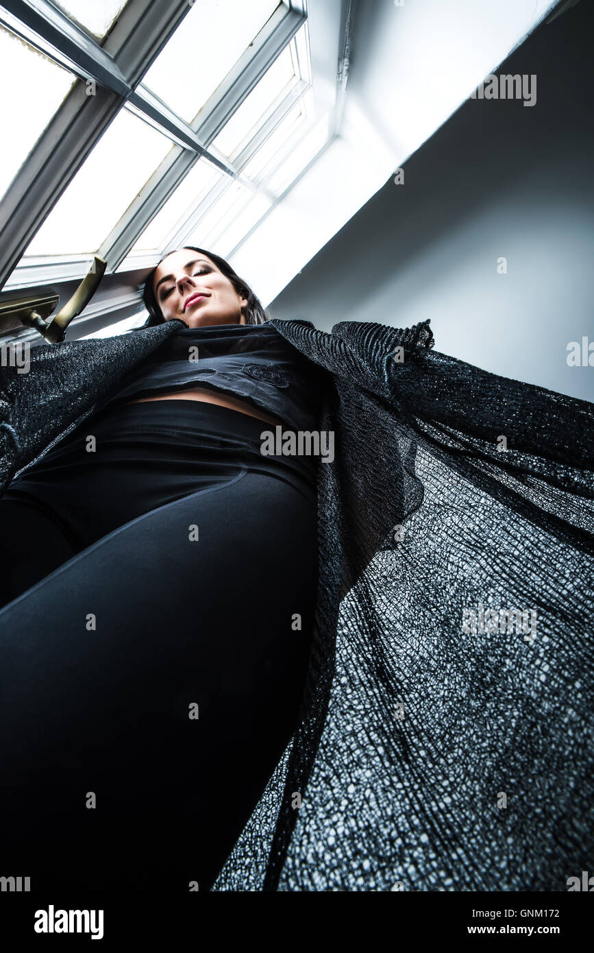 Portrait of a beautiful young woman leaning against a door Stock Photo ...