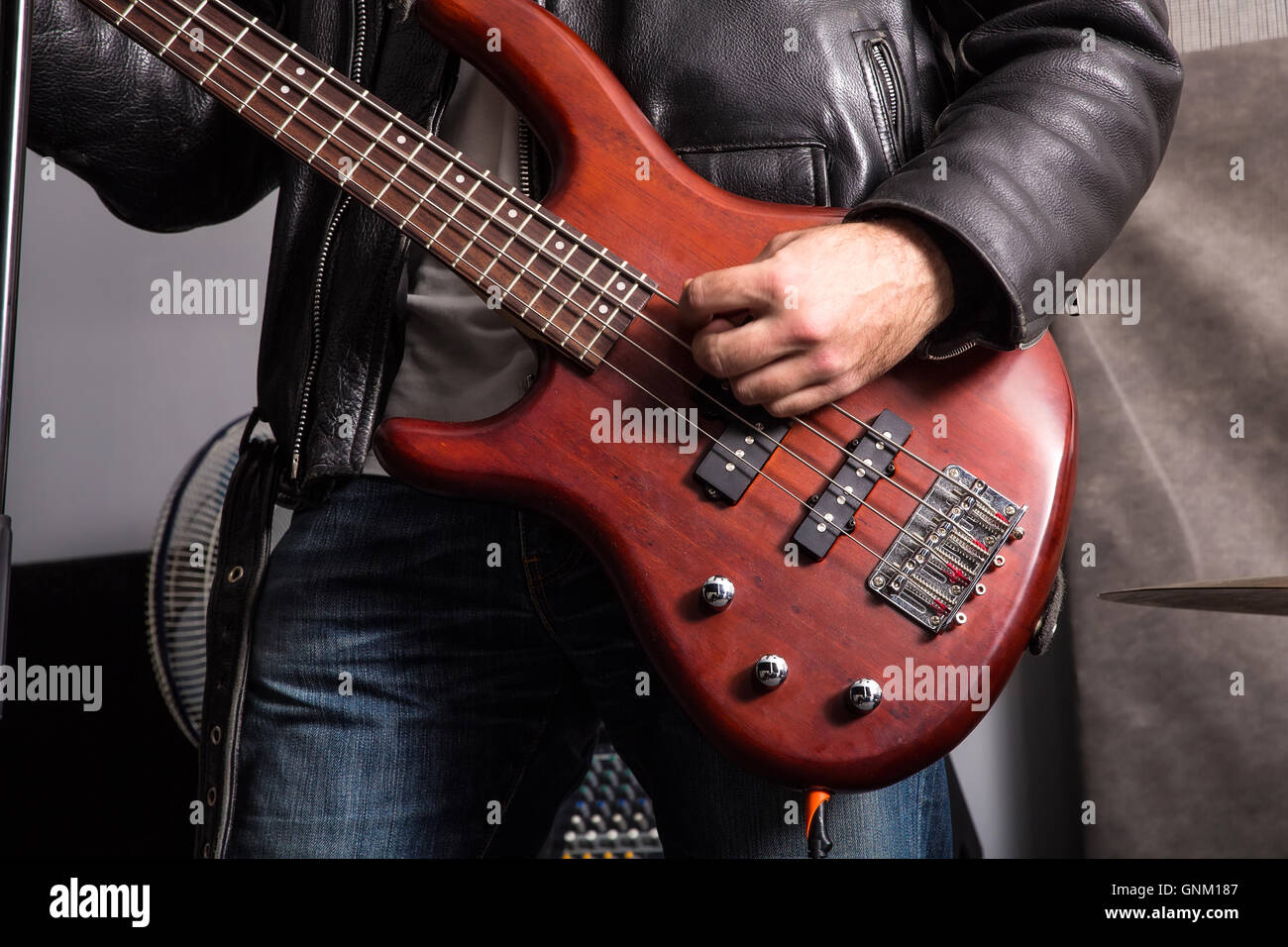 A Rock musician playing passionately bass in the rehearsal Studio Stock ...