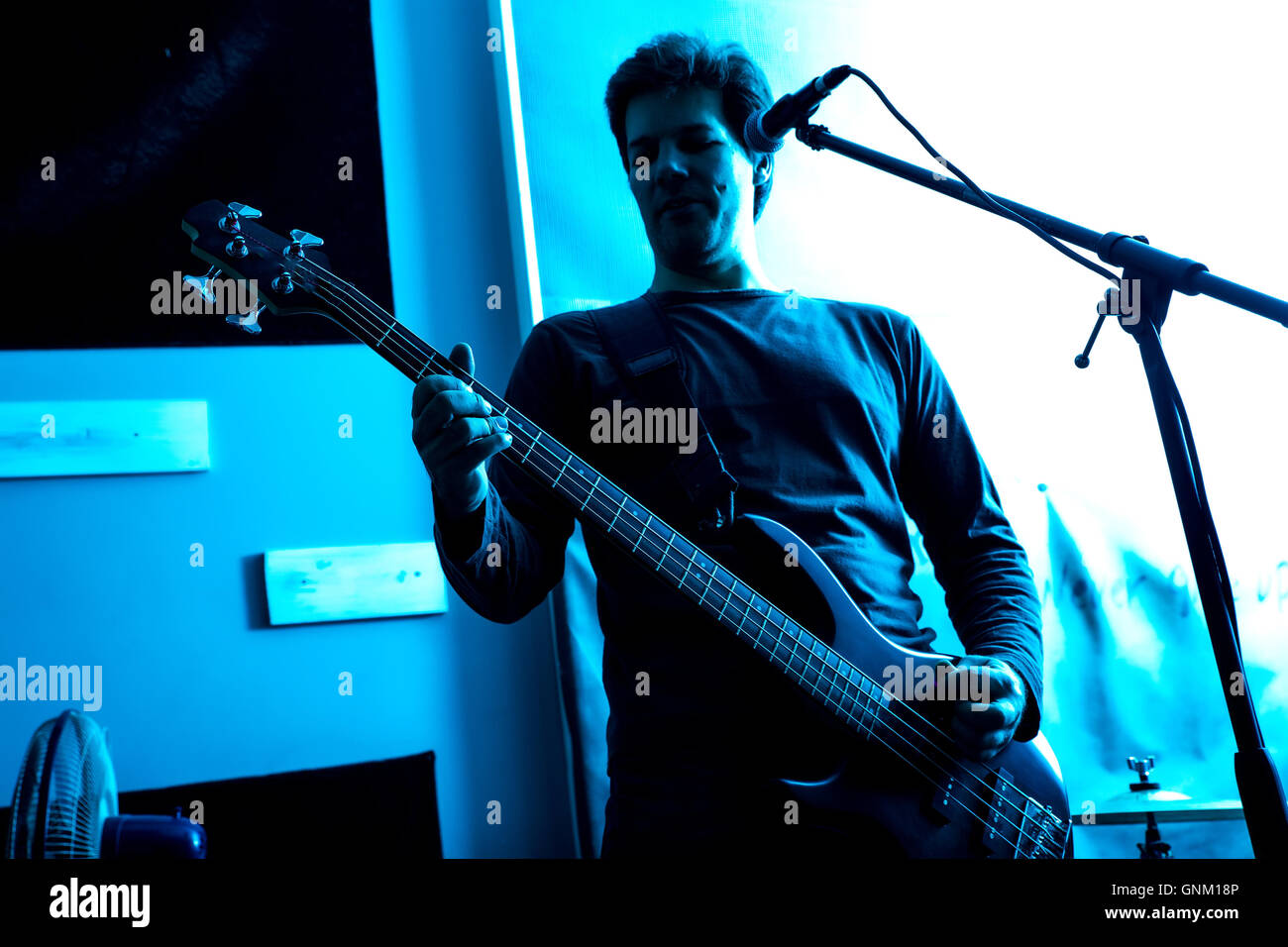 Black and white Portrait of a Rock singer playing bass in the rehearsal ...