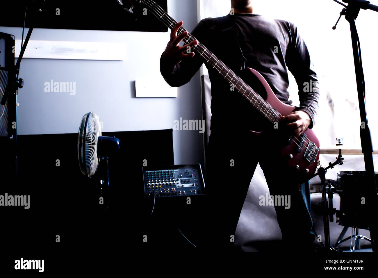 Black and white Portrait of a Rock singer playing bass in the rehearsal ...