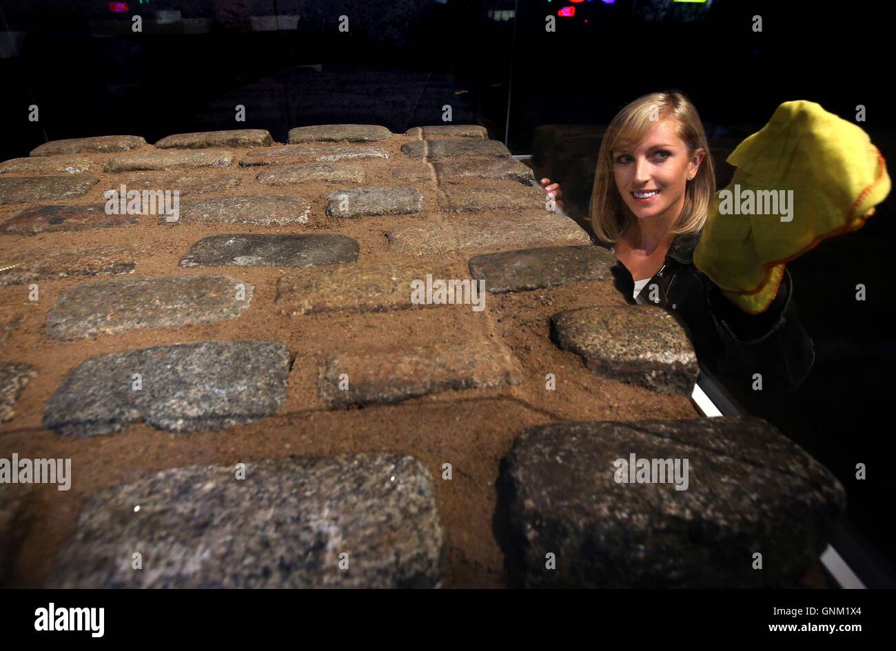 Laura Good polishes the cabinet which holds the original cobbles from ...