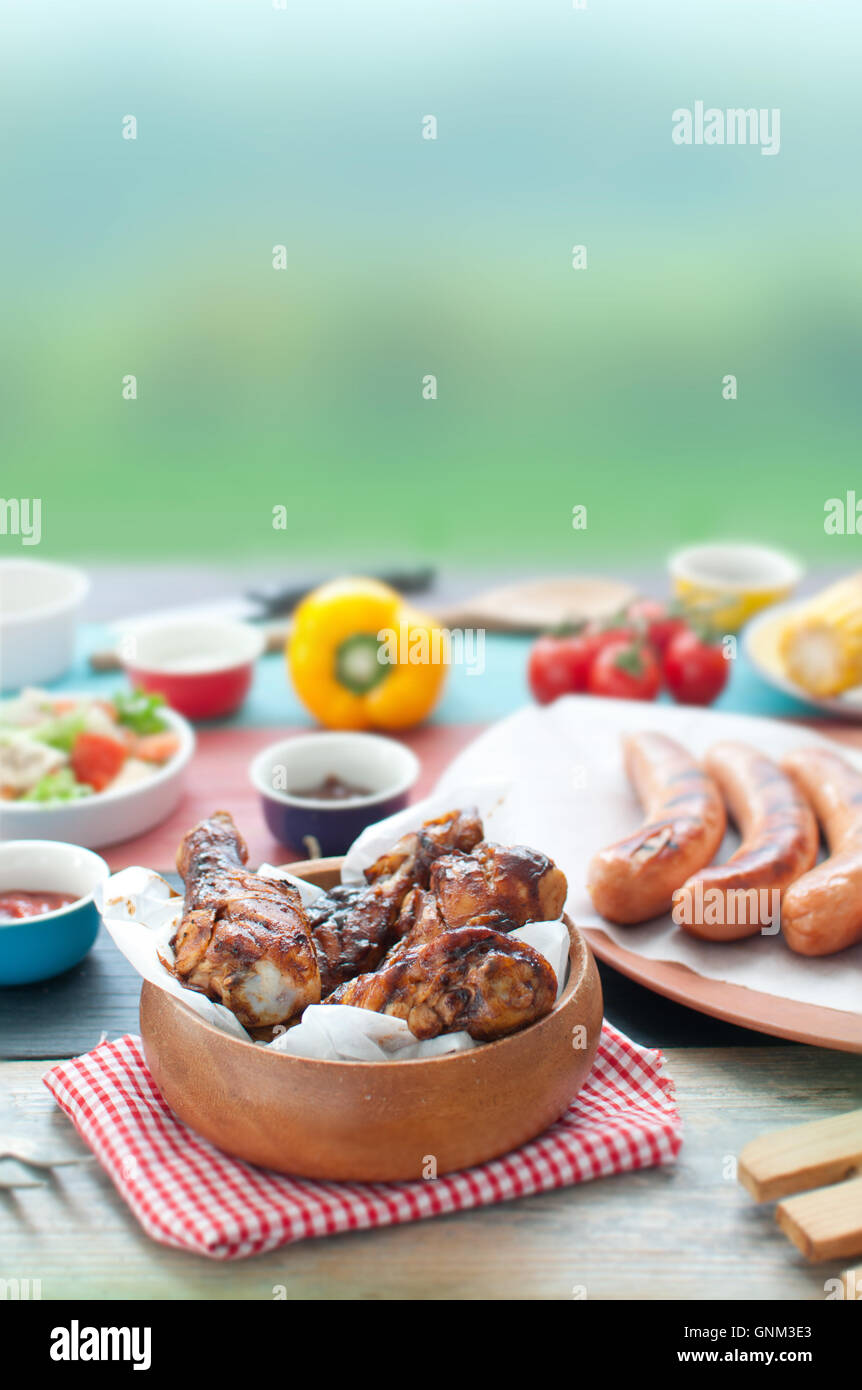 Selection of grilled barbecue meat including chicken and sausages with ...