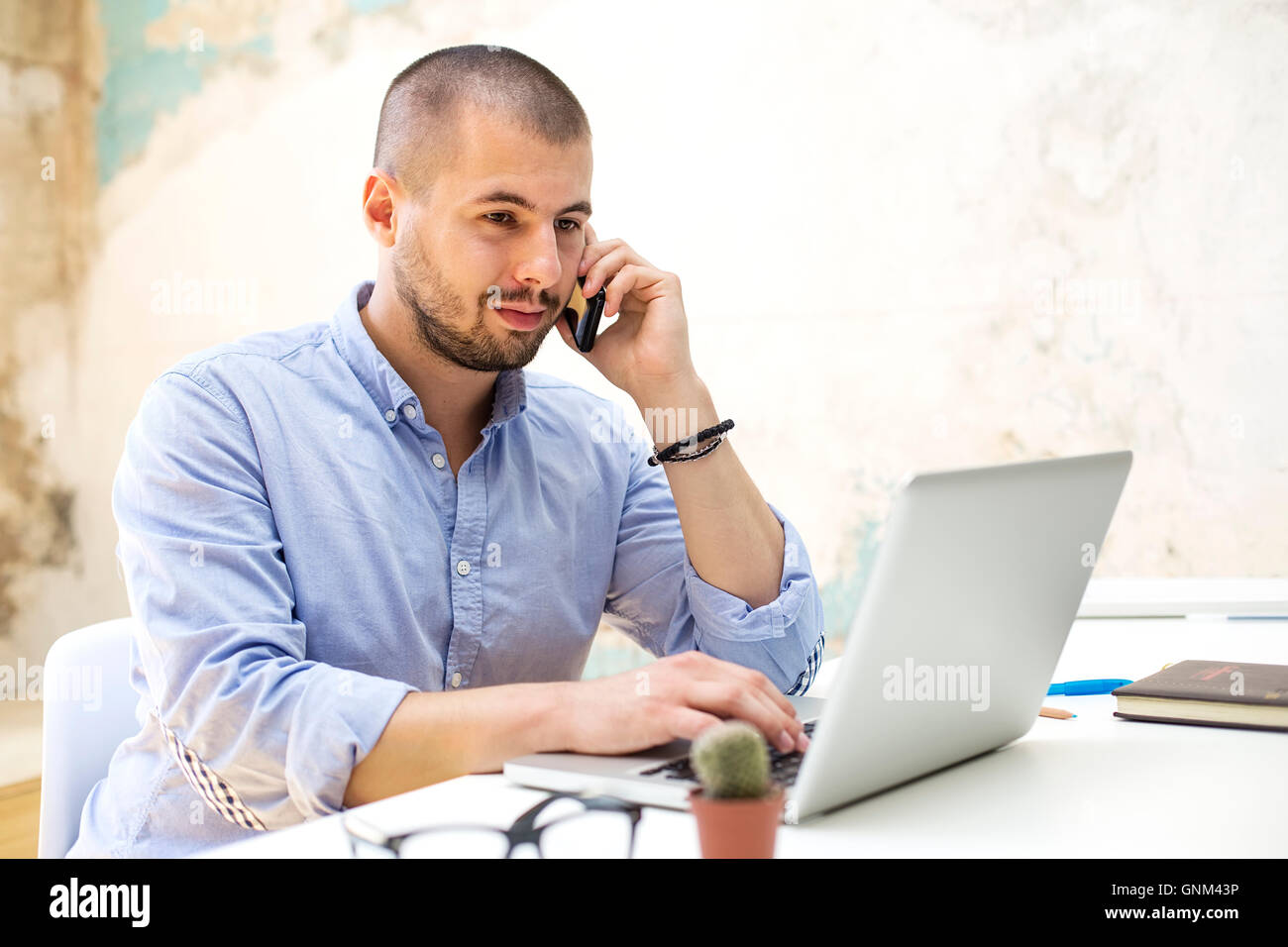 Man working phone laptop in hi-res stock photography and images - Alamy