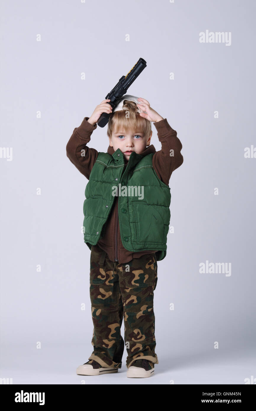 little boy with gun on white Stock Photo - Alamy