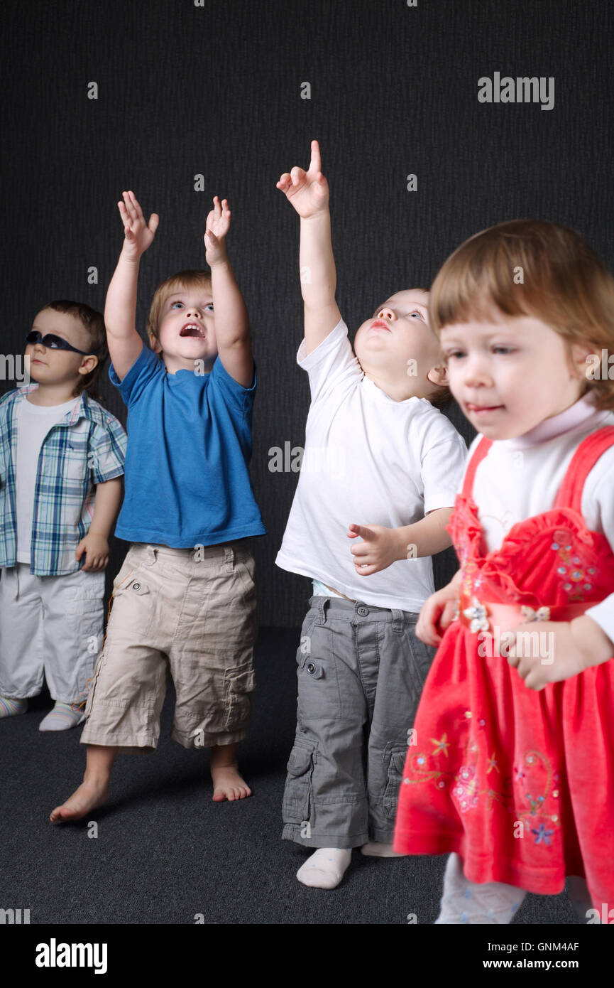 children pointing up on dark background Stock Photo - Alamy