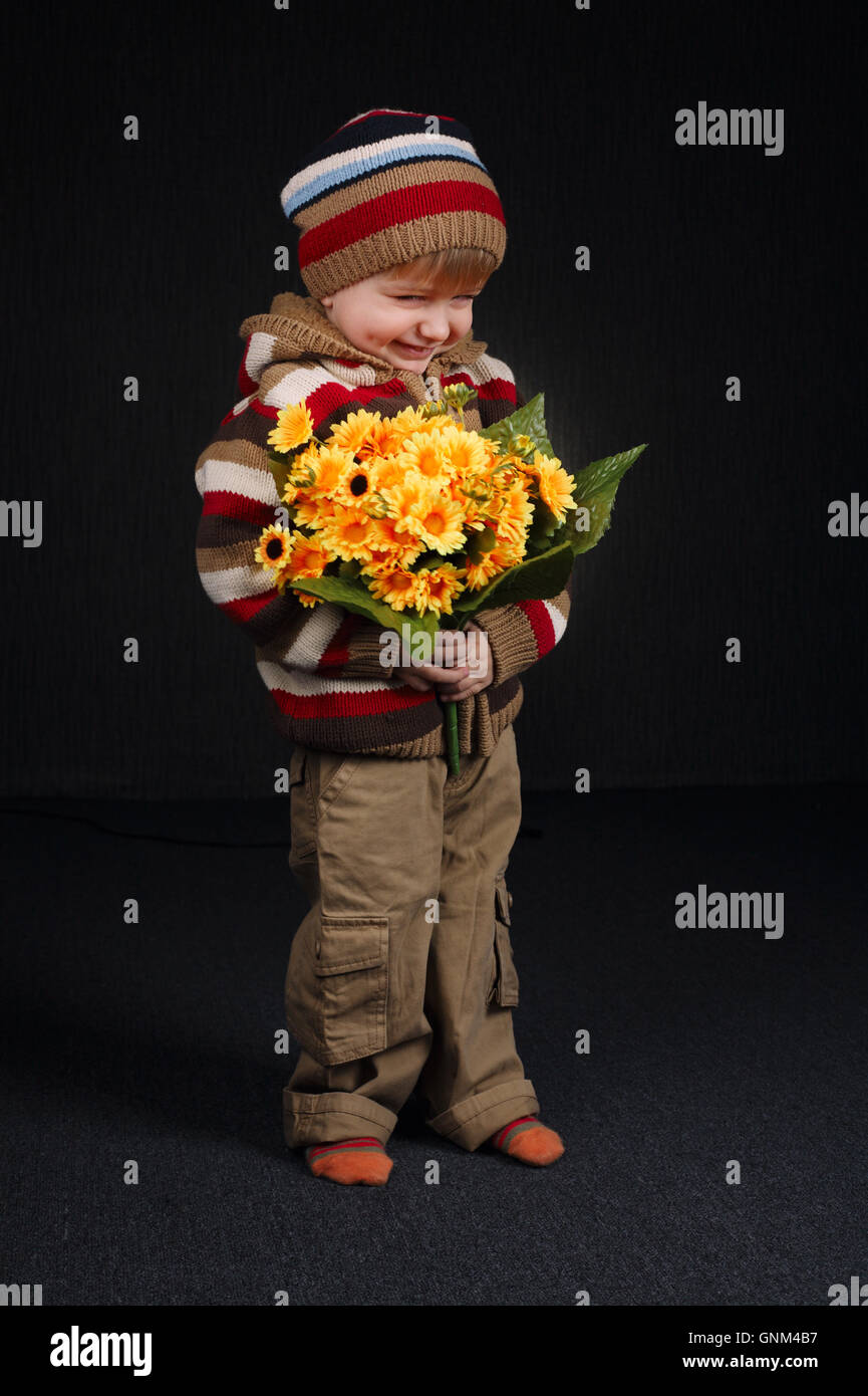 little sweet boy with flowers Stock Photo - Alamy