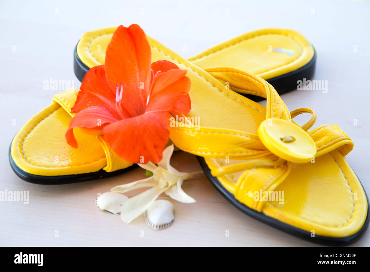 Yellow summer slippers Stock Photo - Alamy