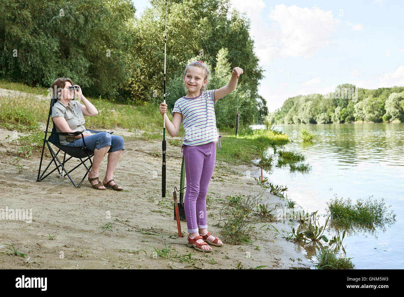 Child girl look on caught fish hi-res stock photography and images - Alamy