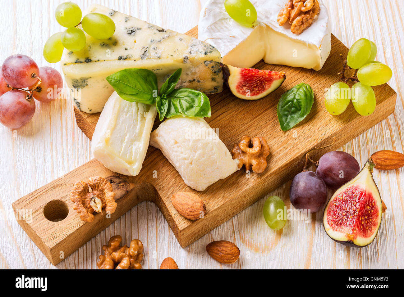 Cheese platter with figs, grapes and nuts Stock Photo - Alamy
