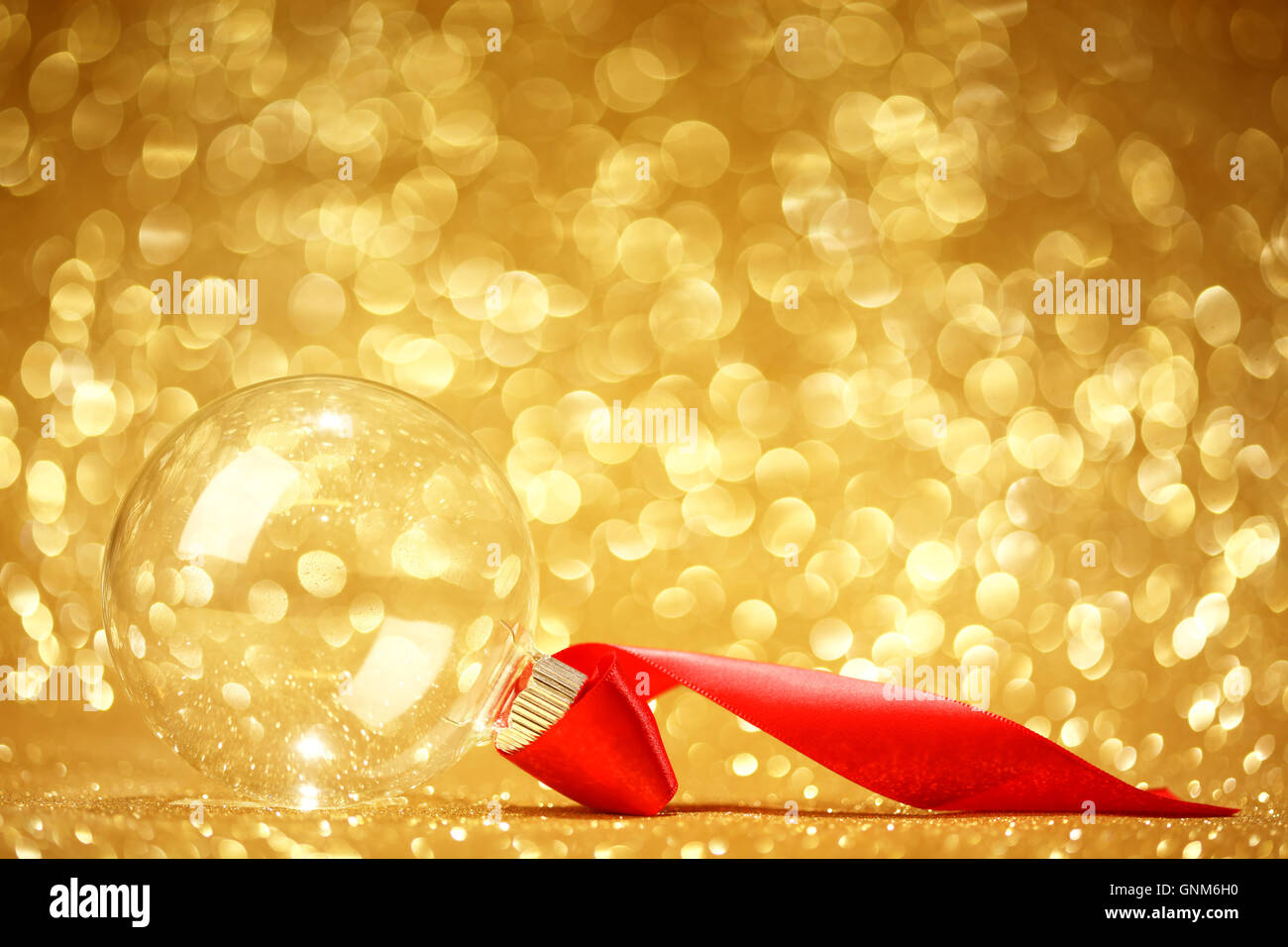 Clear christmas decoration on gold background Stock Photo - Alamy