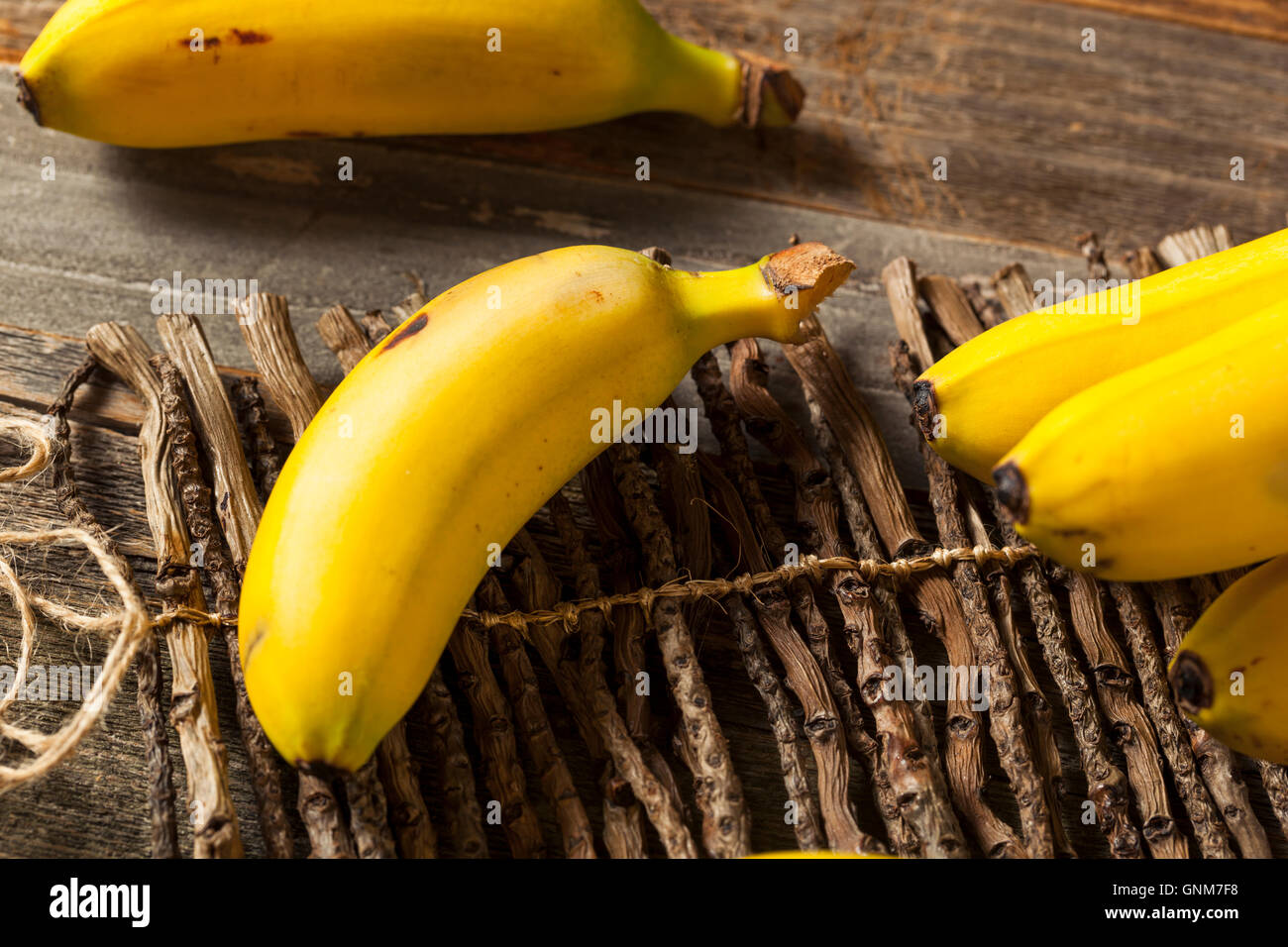 Raw Organic Yellow Baby Bananas in a Bunch Stock Photo - Alamy