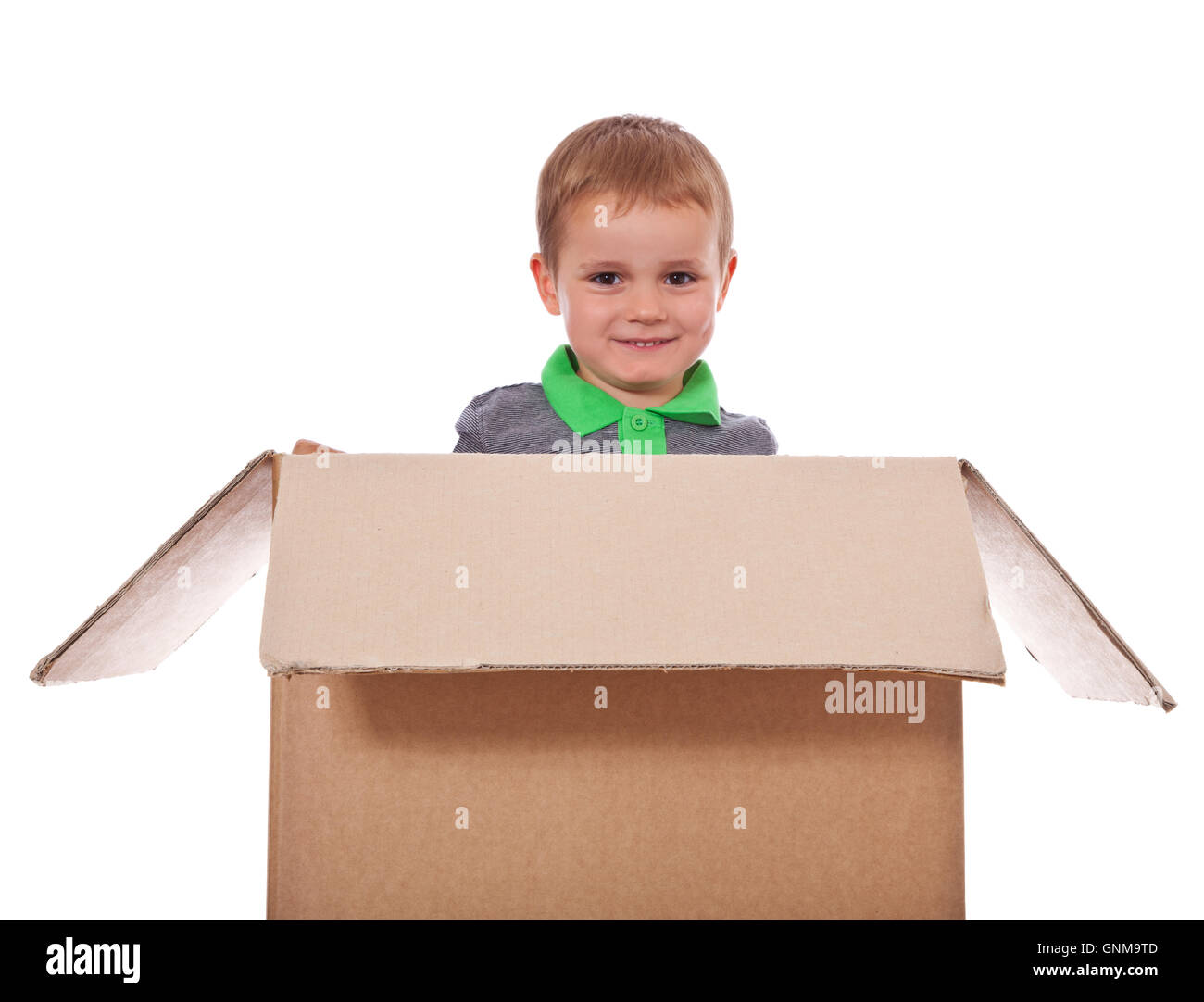 Cute little boy sitting in a box Stock Photo - Alamy