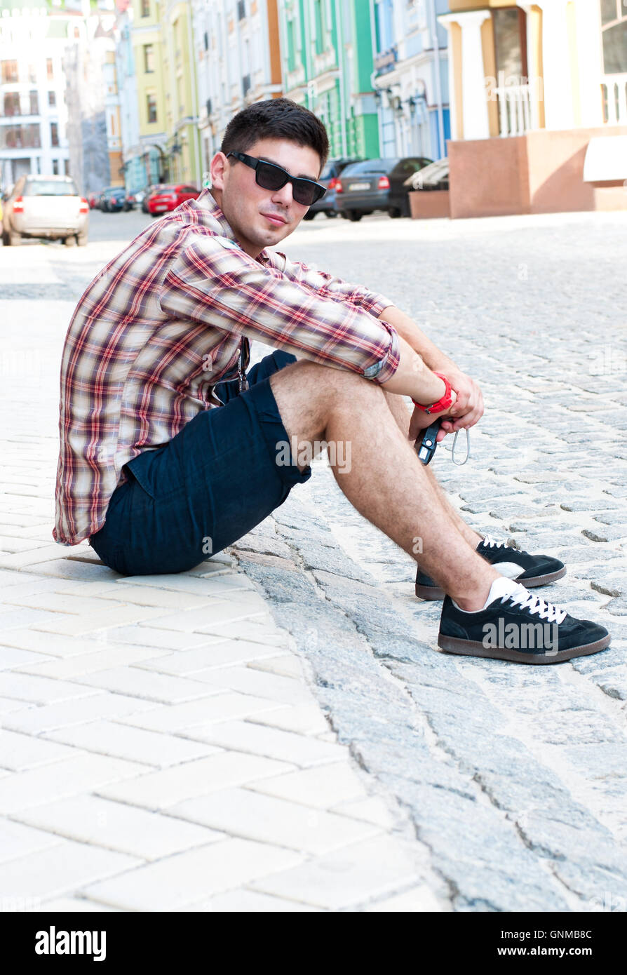 Guy sitting on the sidelines Stock Photo - Alamy