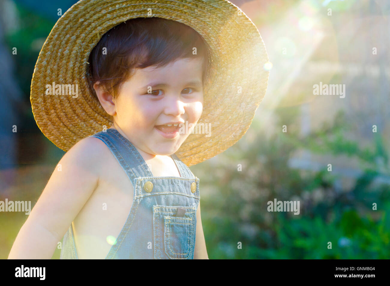 little baby boy gardener smiling playful with sunburst Stock Photo - Alamy
