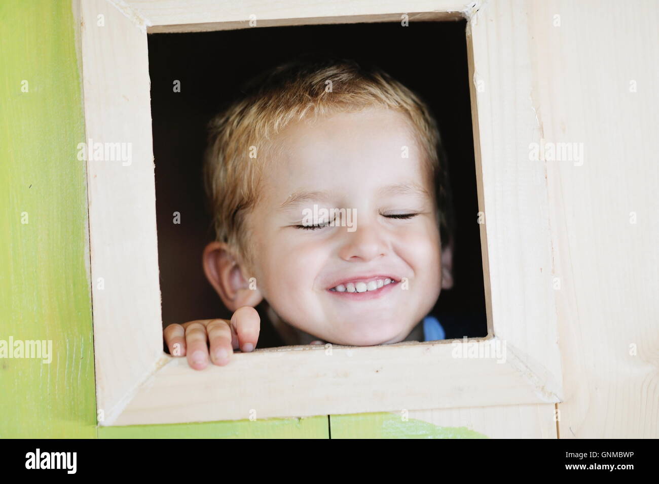 happy child in a window Stock Photo - Alamy
