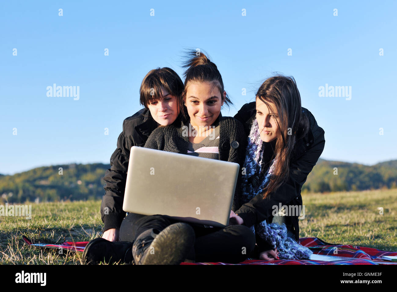 group of teens working on laptop outdoor Stock Photo - Alamy