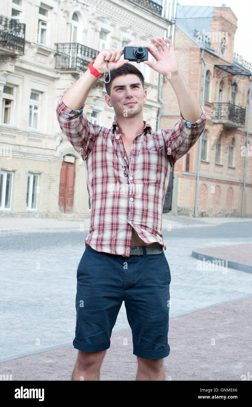 Young smiling man with a camera Stock Photo - Alamy