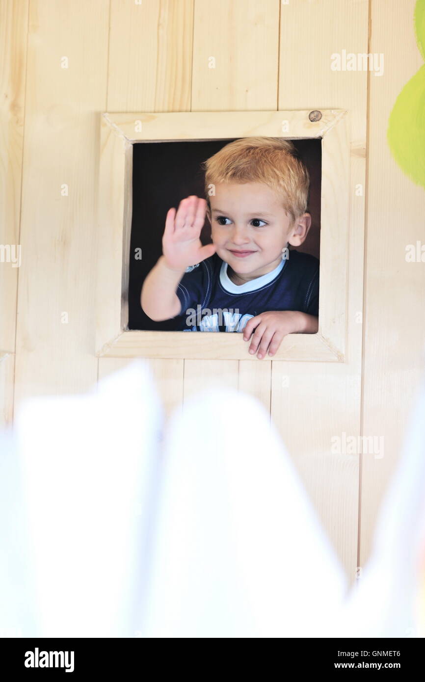happy child in a window Stock Photo - Alamy