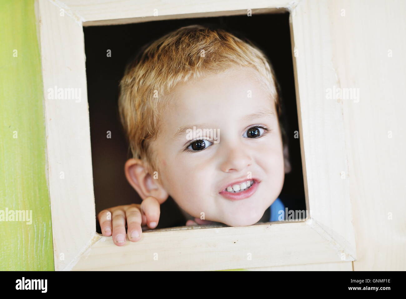 happy child in a window Stock Photo - Alamy