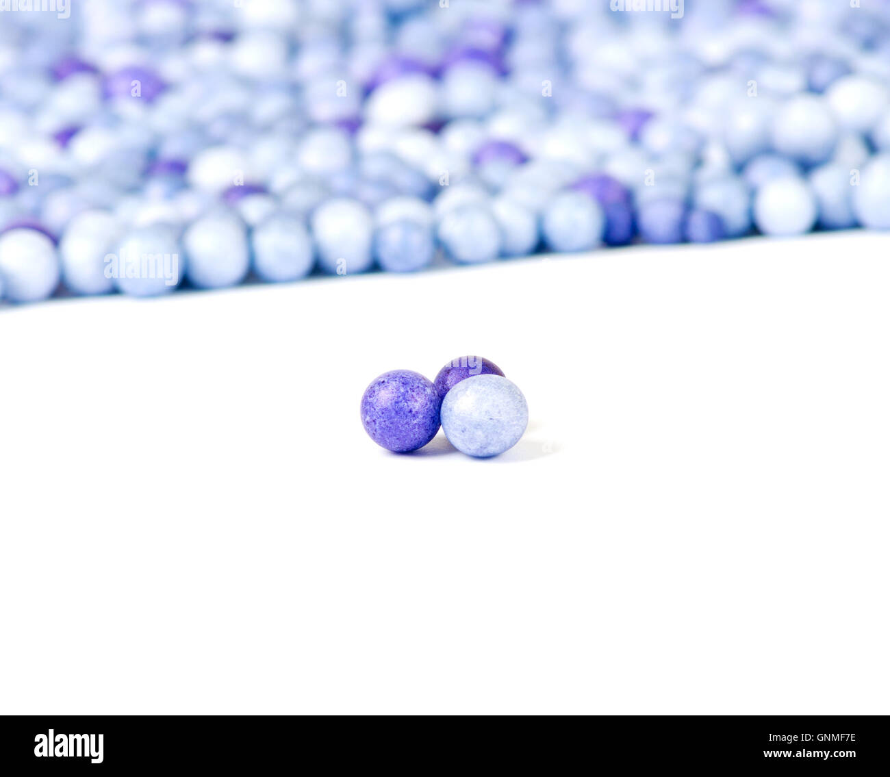 One blue and two violet little pearls Stock Photo - Alamy