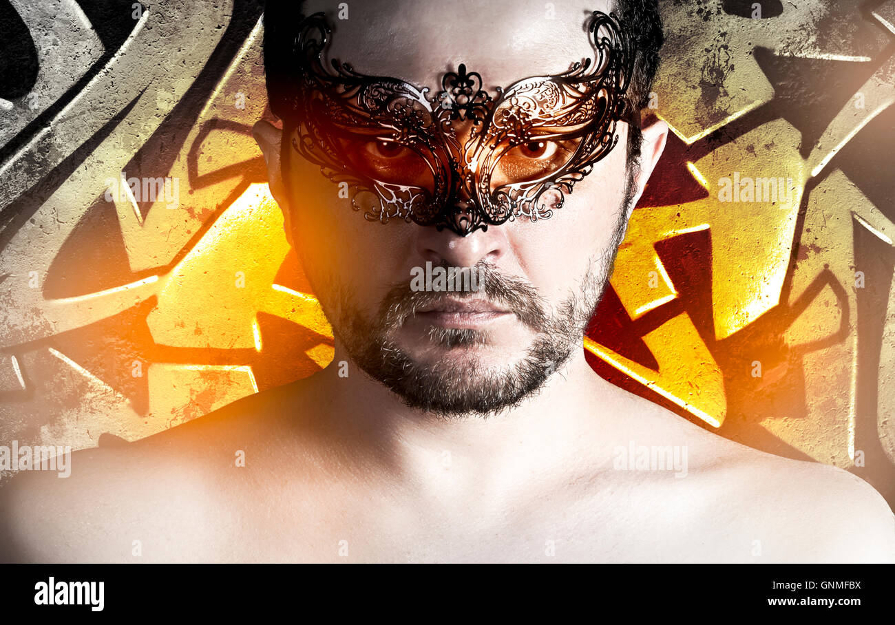 Caucasian men with venetian mask over grafitti background Stock Photo ...
