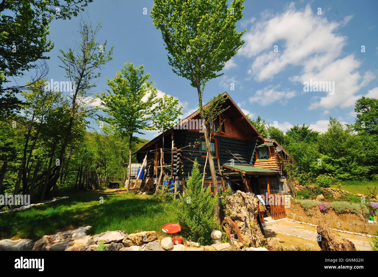 wooden country house with beutiful garden Stock Photo - Alamy