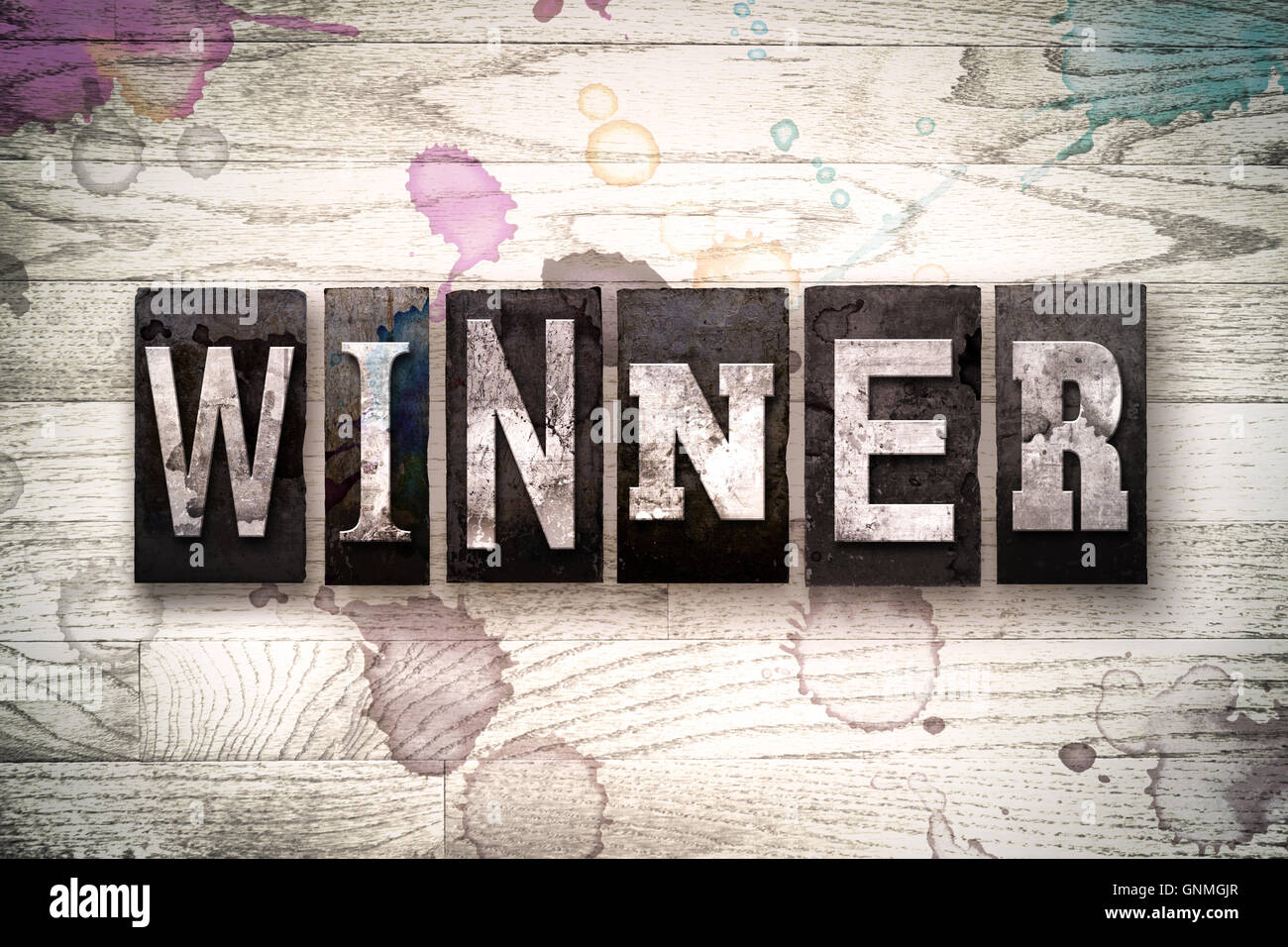 The word "WINNER" written in vintage, dirty metal letterpress type on a ...