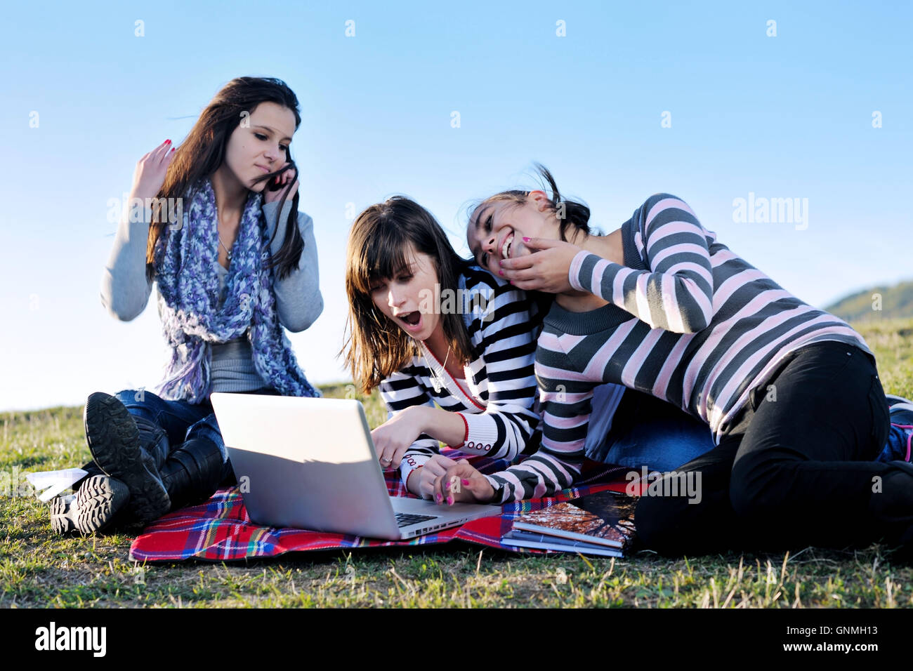 group of teens working on laptop outdoor Stock Photo - Alamy