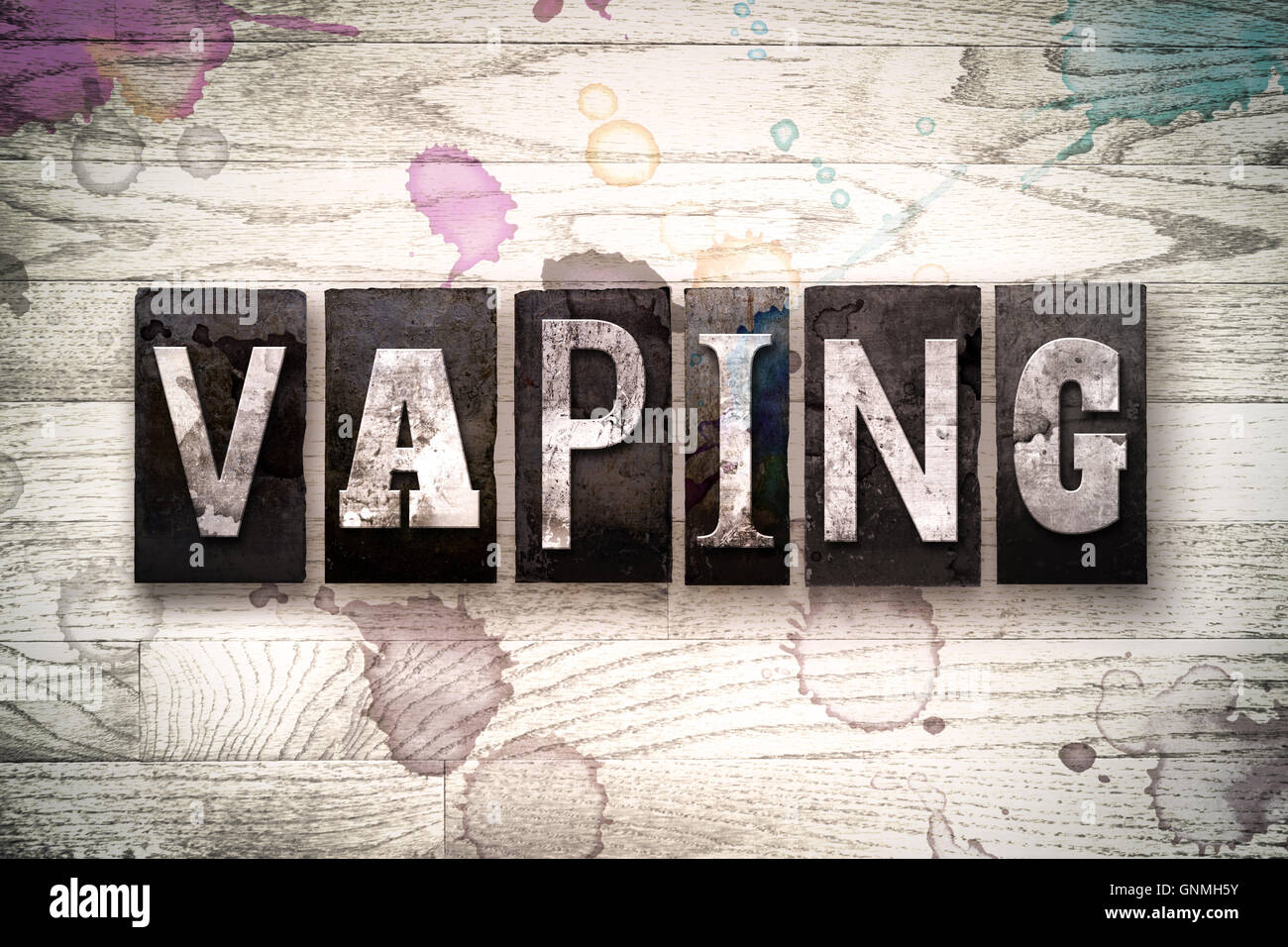 The word "VAPING" written in vintage, dirty metal letterpress type on a ...