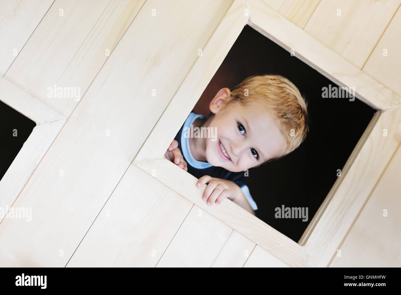 happy child in a window Stock Photo - Alamy