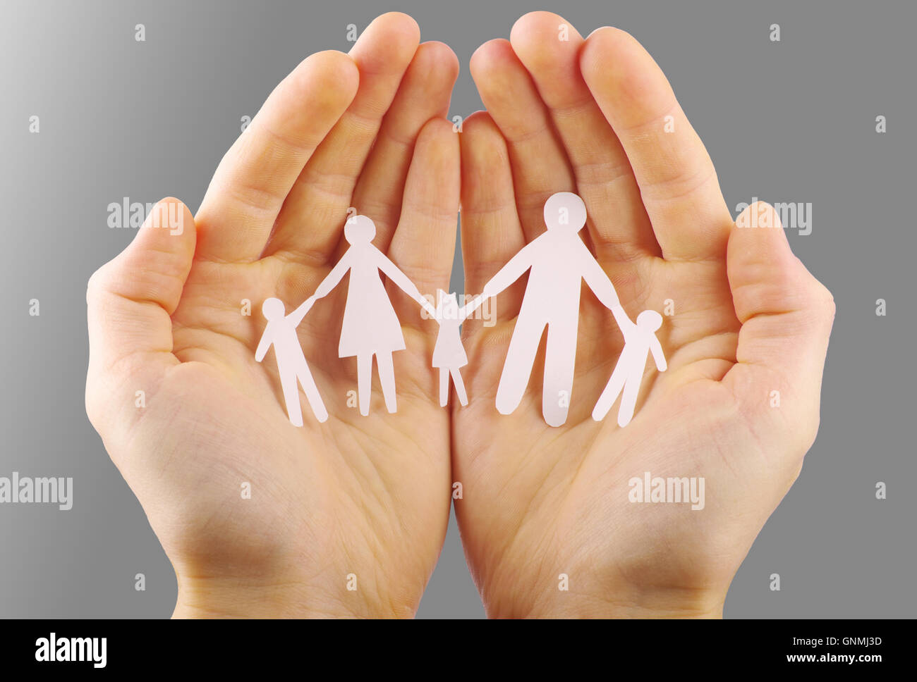 Paper family in hands Stock Photo - Alamy