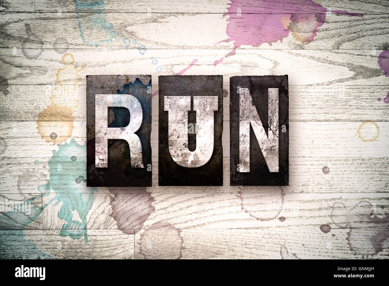 The word "RUN" written in vintage, dirty metal letterpress type on a ...
