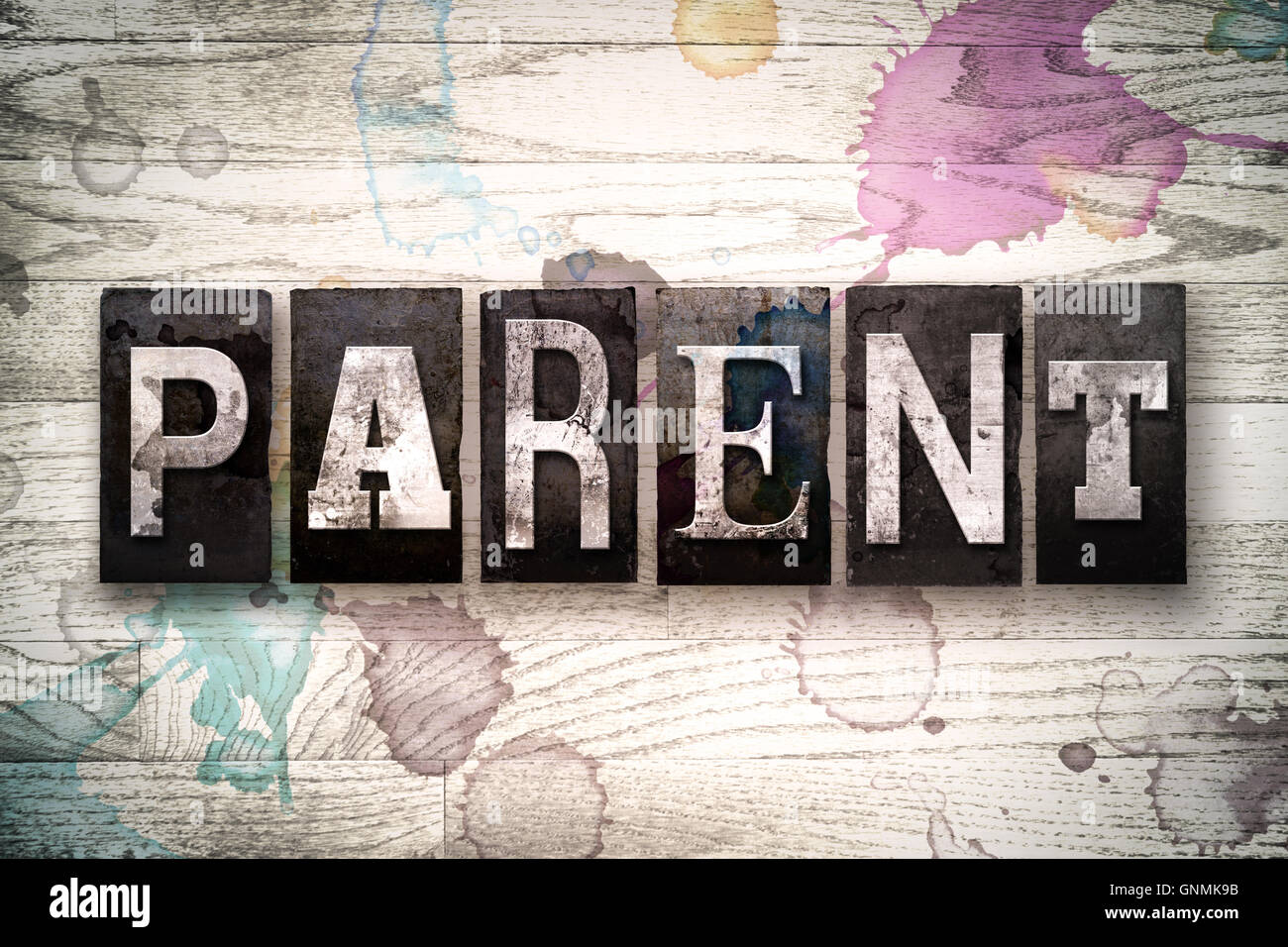 The word "PARENT" written in vintage, dirty metal letterpress type on a ...