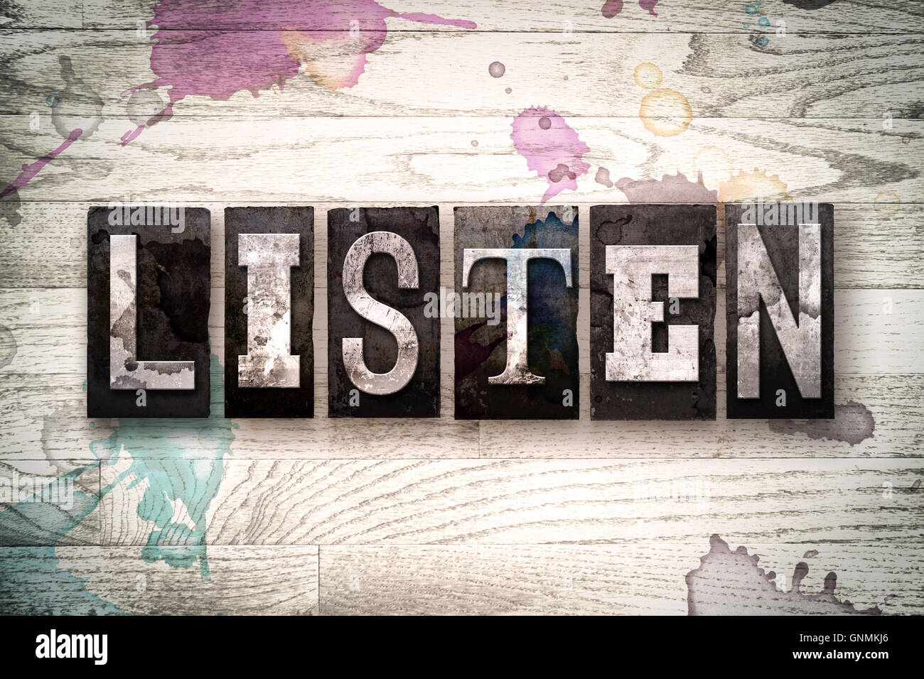 The word "LISTEN" written in vintage, dirty metal letterpress type on a ...