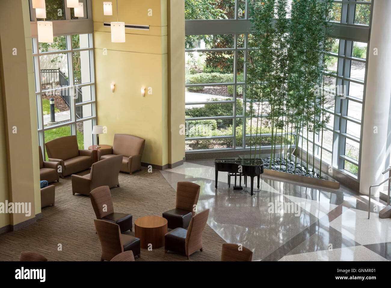 Lobby Atrium area with a piano and chairs near windows Stock Photo - Alamy