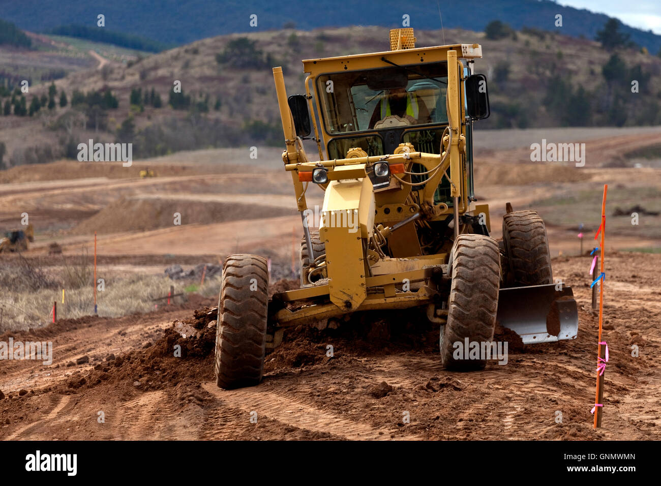 Earth moving grader working on new housing project Stock Photo - Alamy