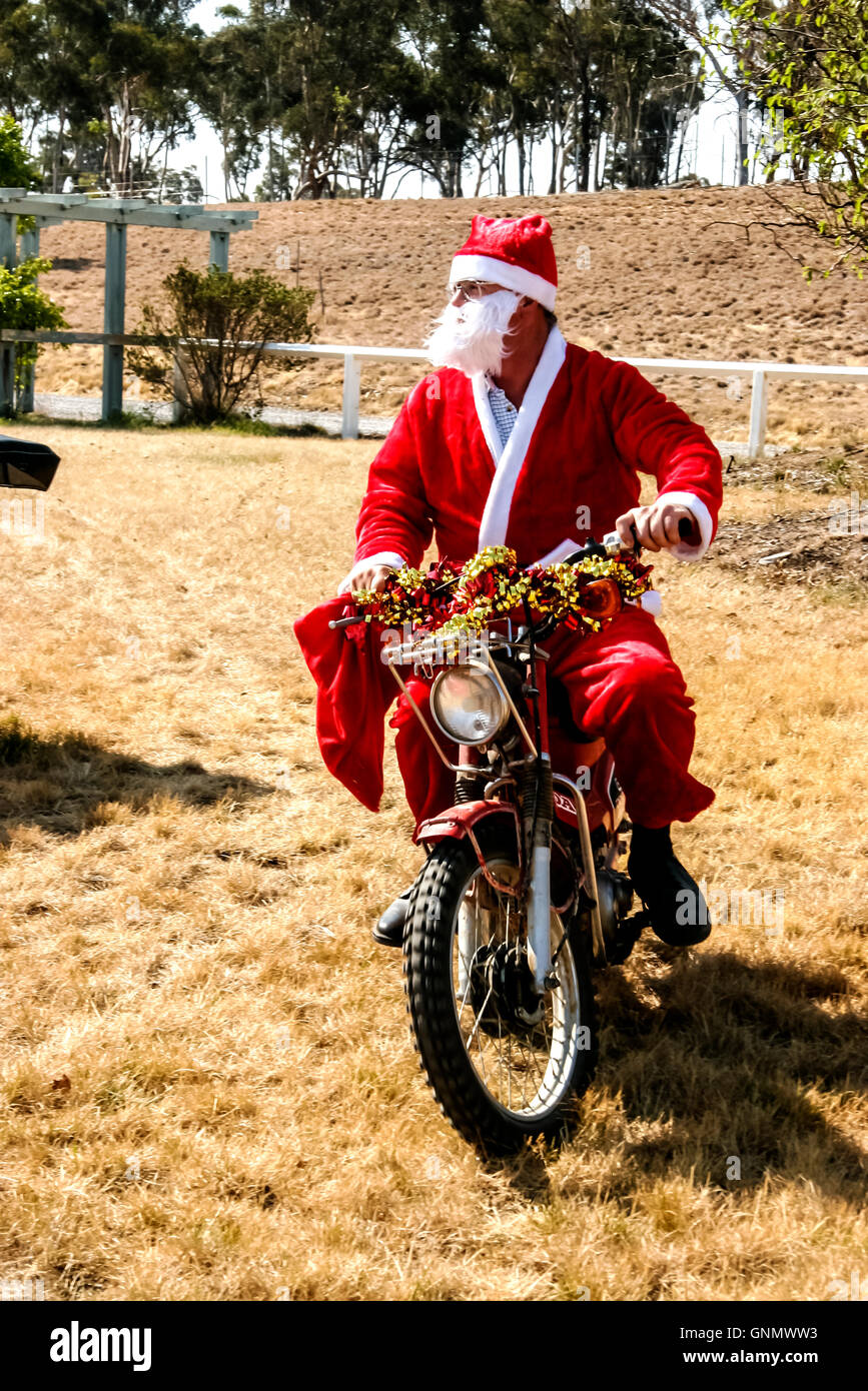 Santa arrives on motorbike in outback Australia Stock Photo - Alamy