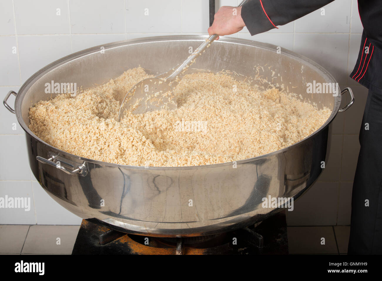 chef cooking rice at a commercial kitchen Stock Photo - Alamy