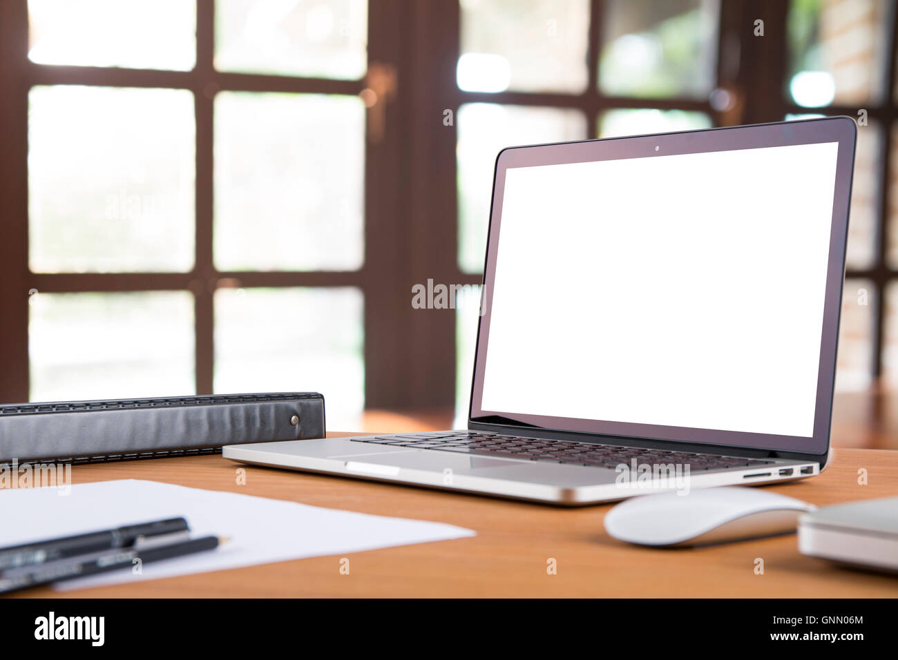 Morning time with warm light. Blank laptop screens on working wooden ...