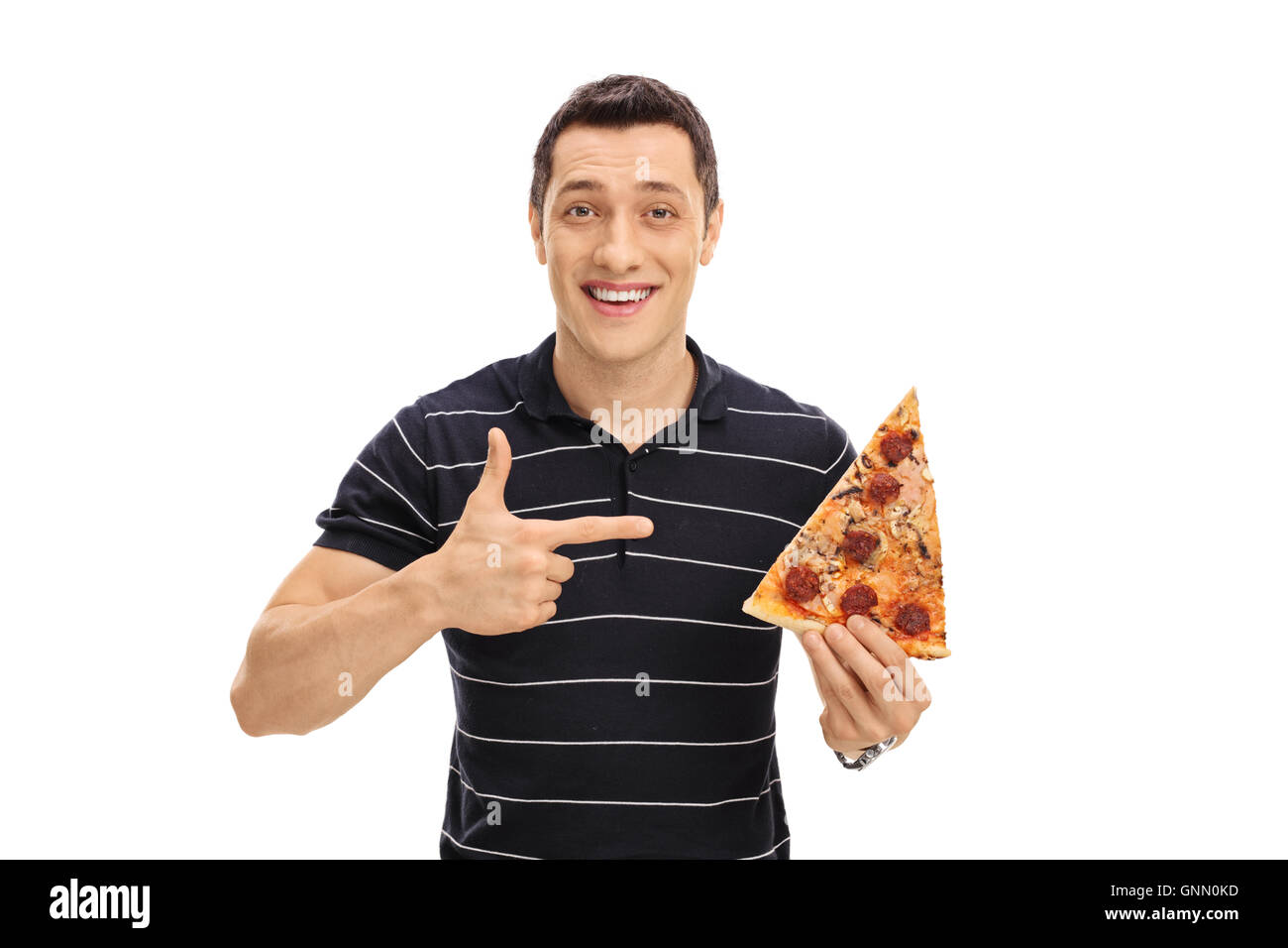 Young man holding a pizza slice and pointing at it isolated on white ...