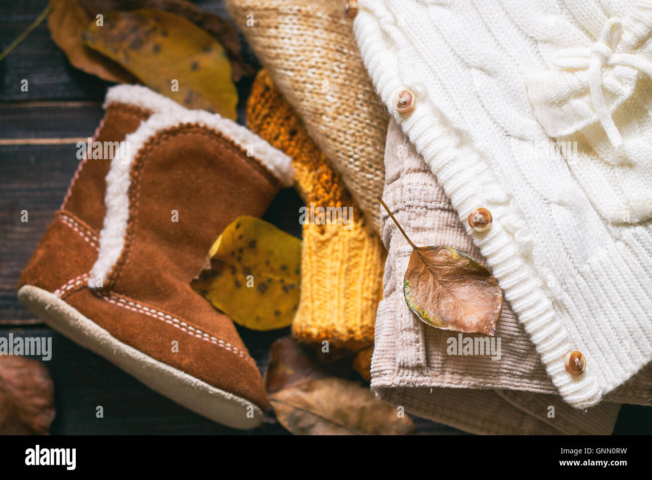 Stack of fall baby clothes on wooden background. Top view Stock Photo ...