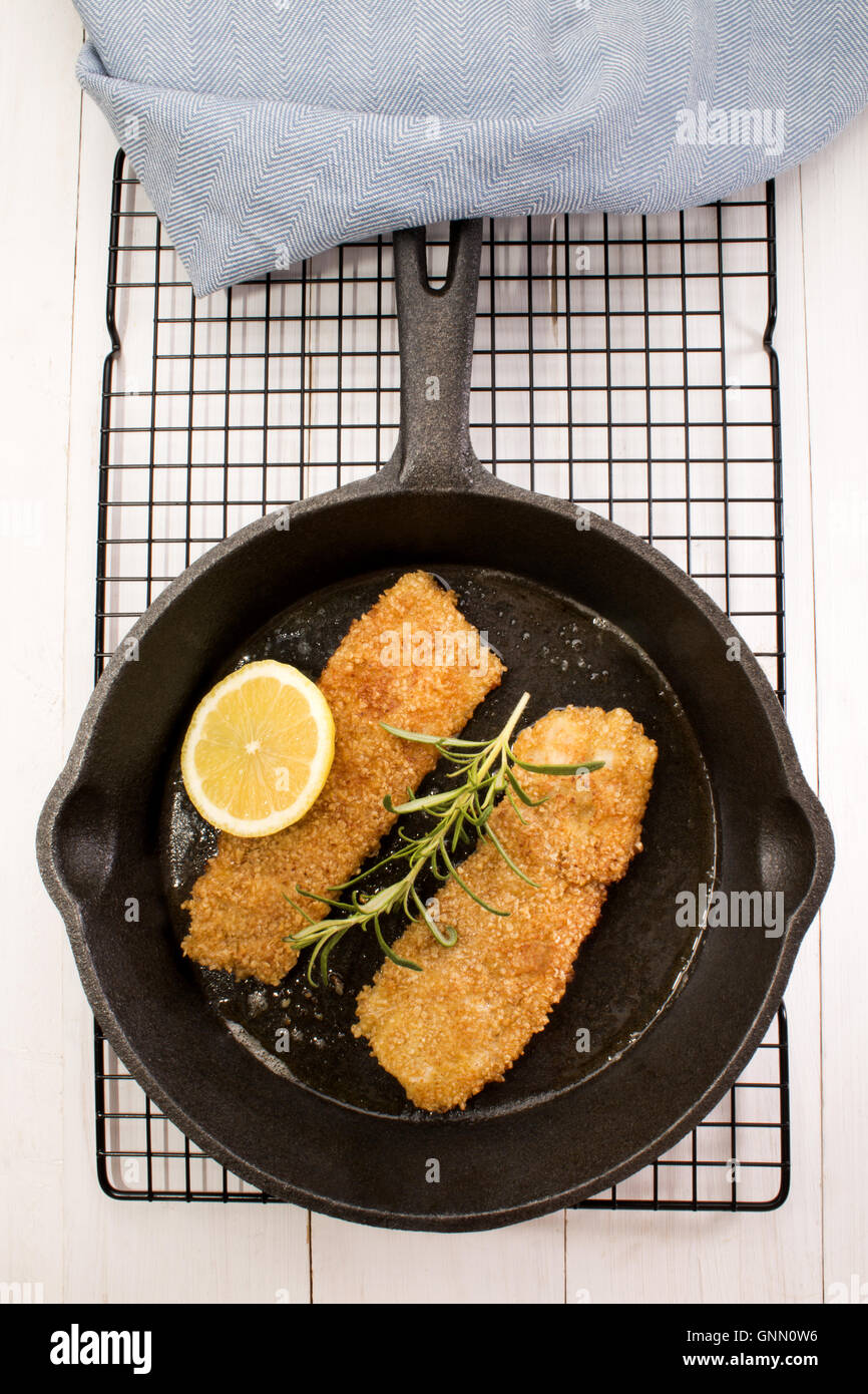 grilled scottish kipper with oat bran, slice lemon, rosemary in a cast ...