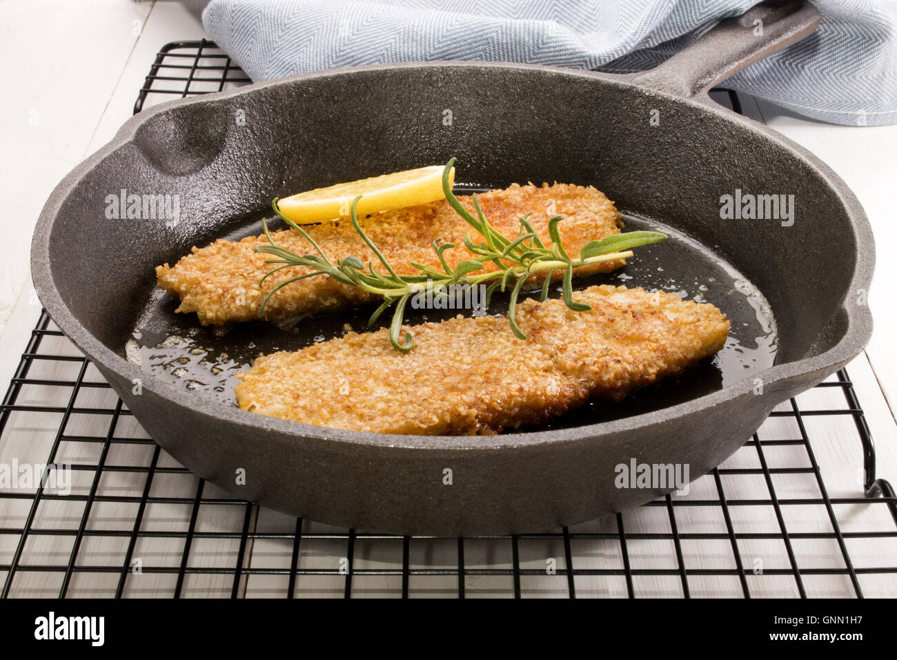 grilled scottish kipper with oat bran, slice lemon, rosemary in a cast ...