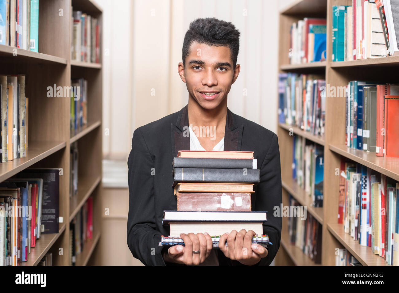 Handsome man in library Stock Photo - Alamy