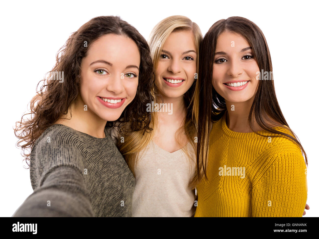 Studio portrait of three beautiful teenage girls smiling Stock Photo ...